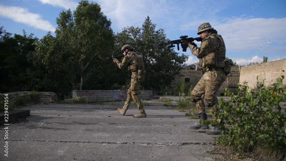 Special forces rangers in battle uniform, armed with assault service ...