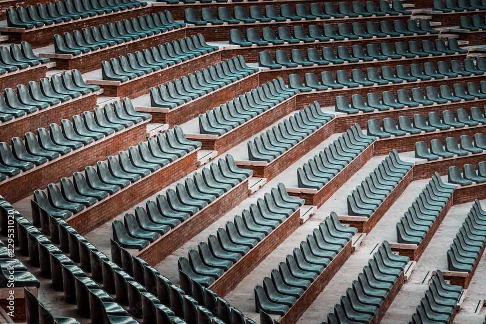 Free unclaimed seats in multiple rows. Sunset photo in empty public ...