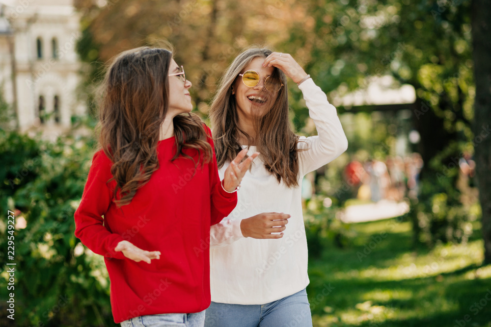 lovely friendly girls walking outdoor and talking with eath other with ...