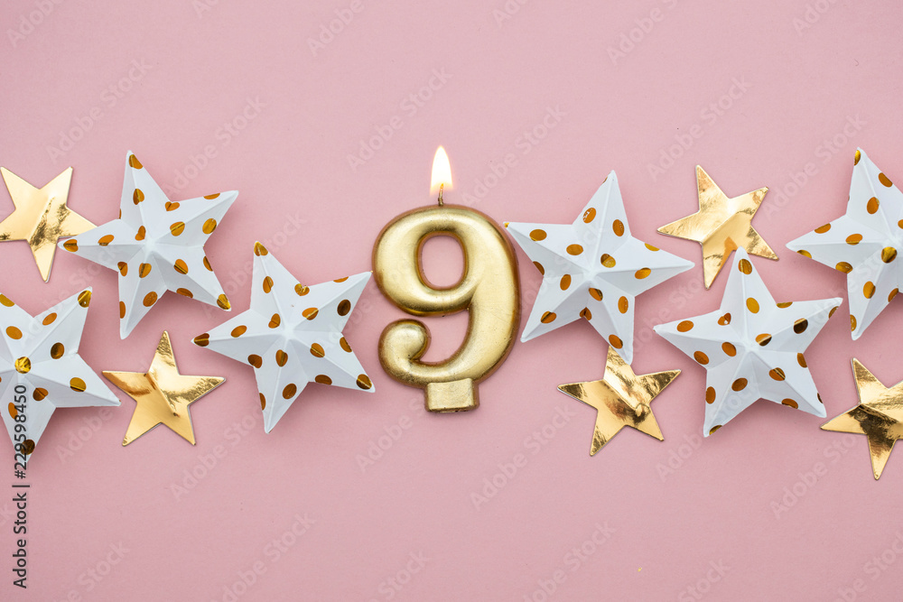 Number 9 gold candle and stars on a pastel pink background Stock Photo ...