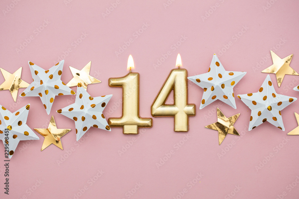Number 14 gold candle and stars on a pastel pink background Stock Photo ...