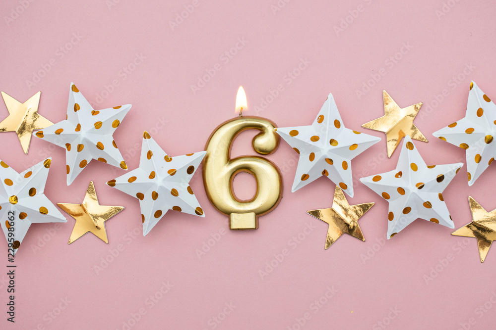 Number 6 gold candle and stars on a pastel pink background Stock Photo ...