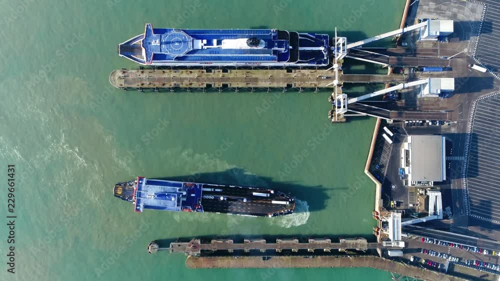 Aerial top down view of ferry moving backwards to dock and embark this ...