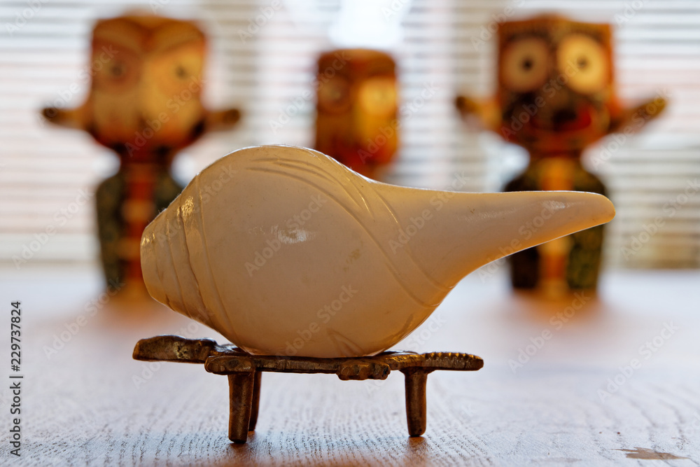 Conch shell and Hindu deity Lord Jagannath in the blurry background ...