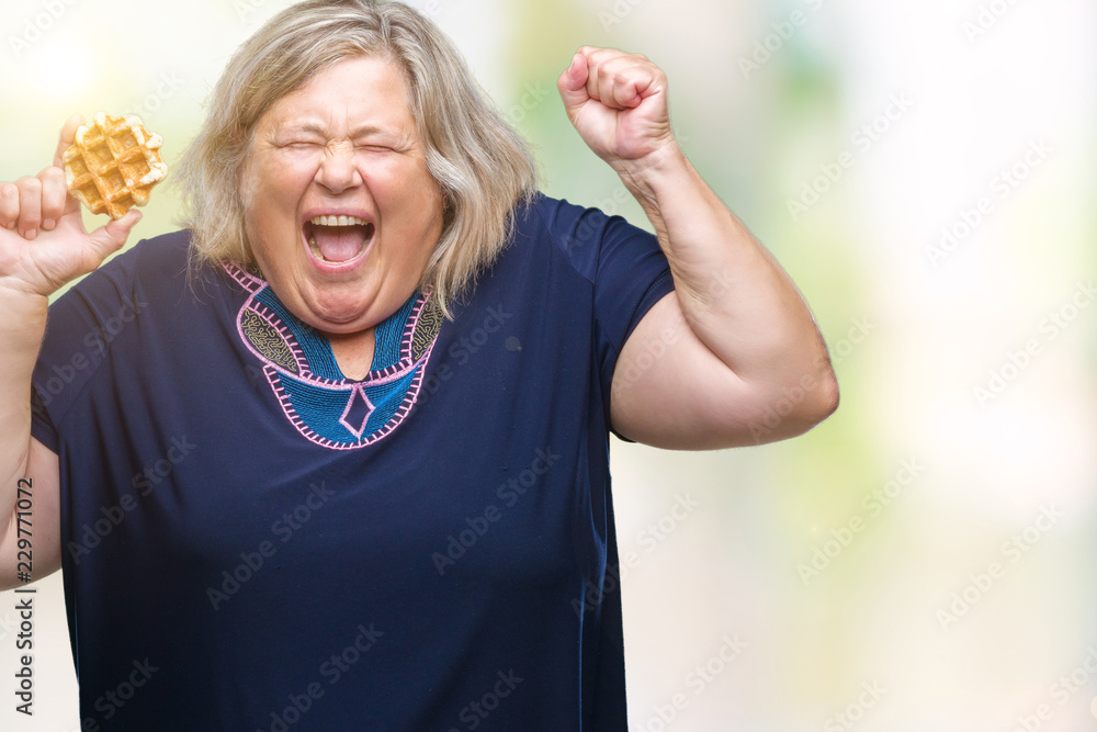 Senior plus size caucasian woman eating waffle over isolated background ...