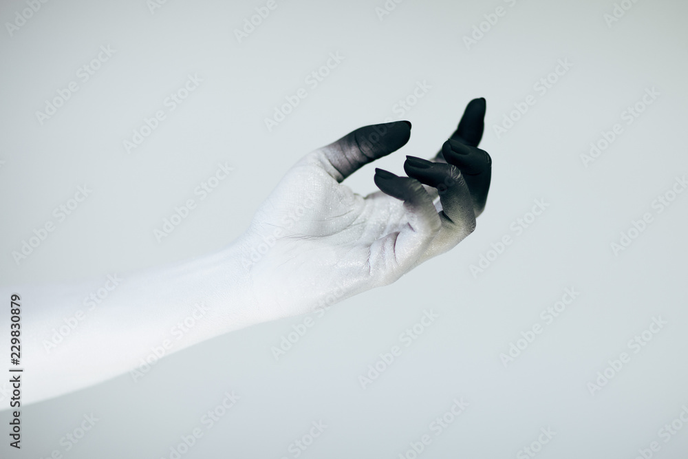 Creepy Halloween monster hand with white and black make up in front of ...