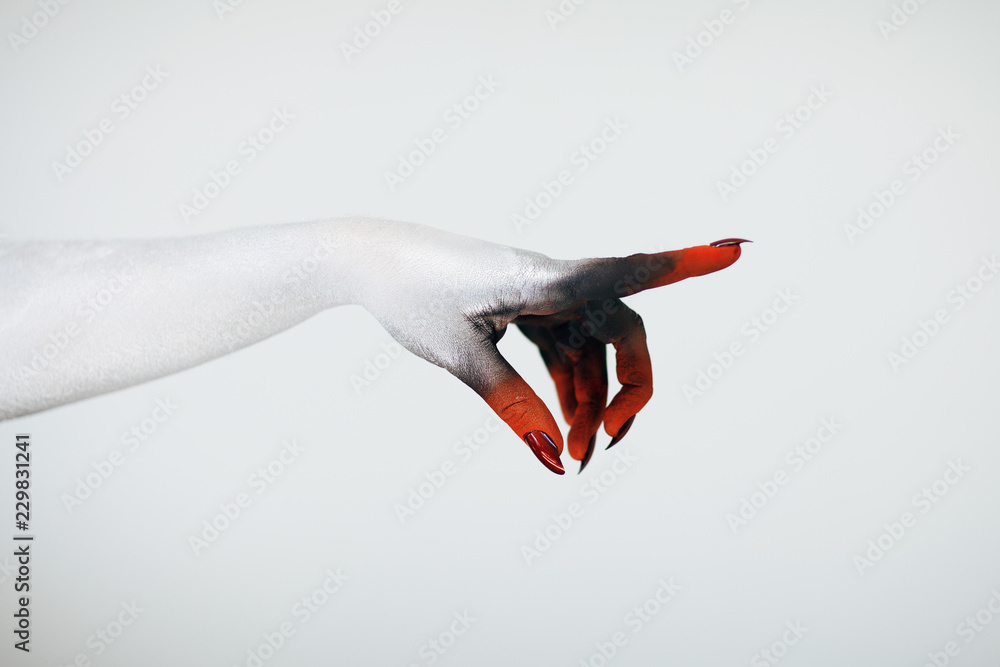 Creepy Halloween monster witch hand with white, red and black make up ...
