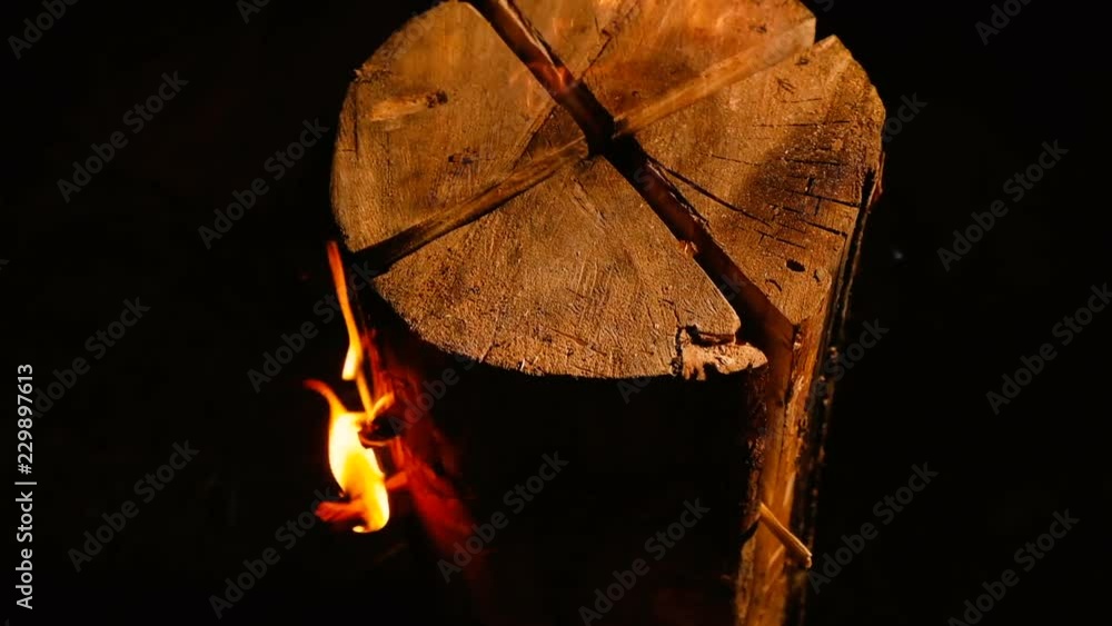 Swedish or finnish log candle. Fire burning from inside the wooden log ...