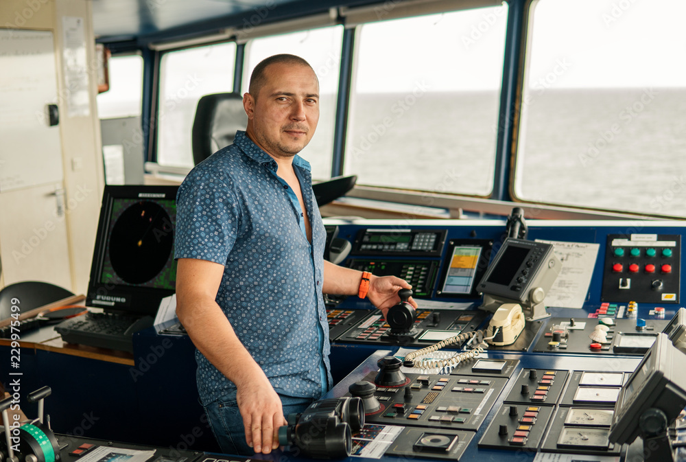 Marine navigational officer or chief mate on navigation watch on ship ...