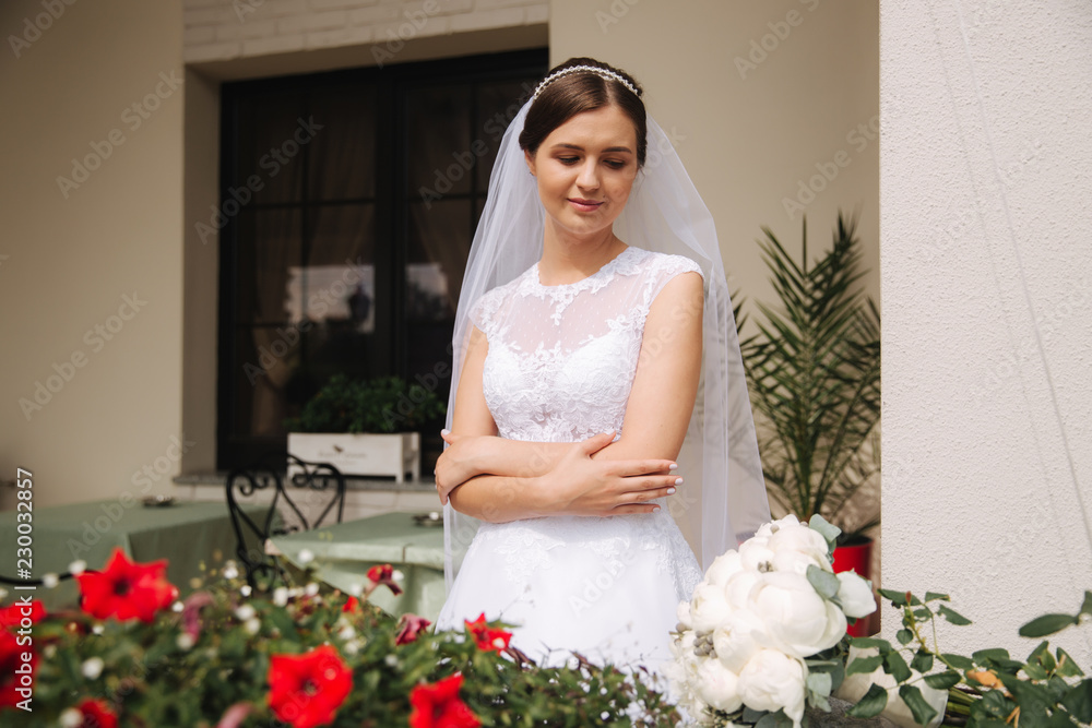 Young lady on her wedding day. Happy bride poses to photographer and ...