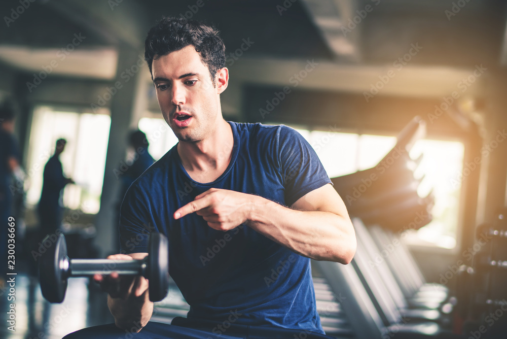 Cinematic tone of young attractive fitness man exercise with machine ...
