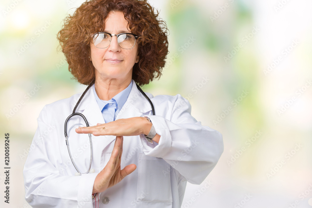 Middle ager senior doctor woman over isolated background Doing time out ...