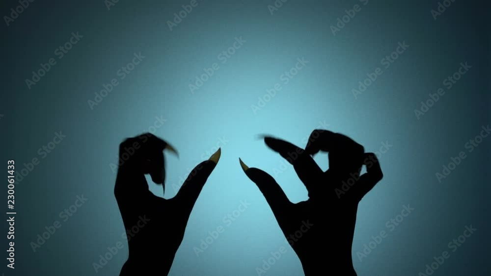 Dark monster hands with sharp nails horrifying victim, eerie horror ...