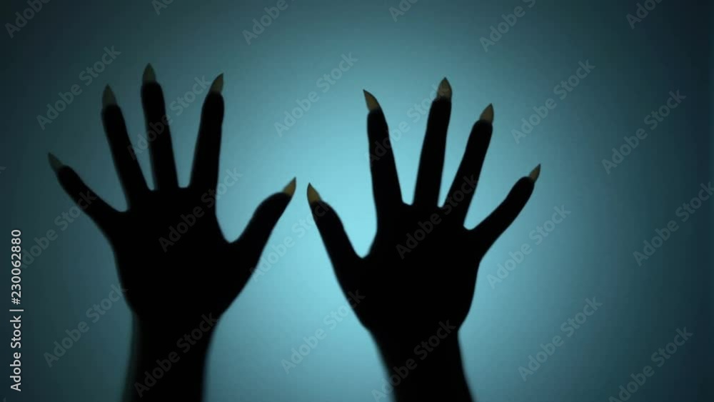 Crooked evil hands with sharp nails beating on glass, horrifying ...