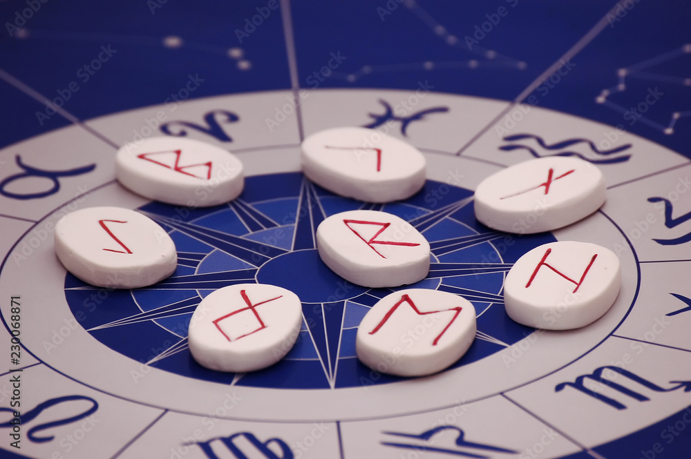 Runes stones lying on horoscope with zodiac symbols like astrology and ...