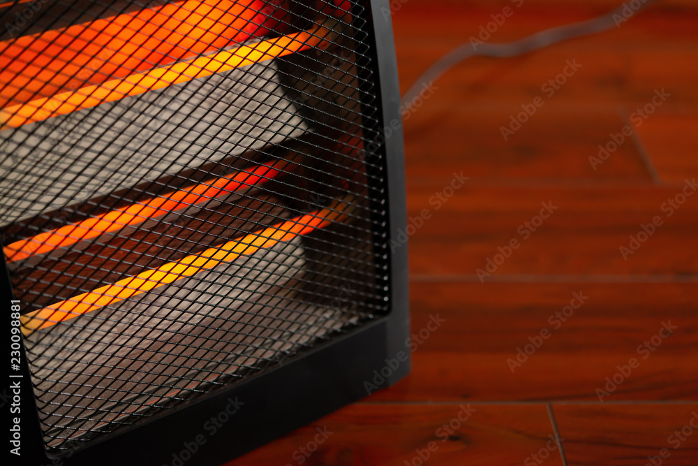 electric heater working in a room with copy space Stock Photo | Adobe Stock