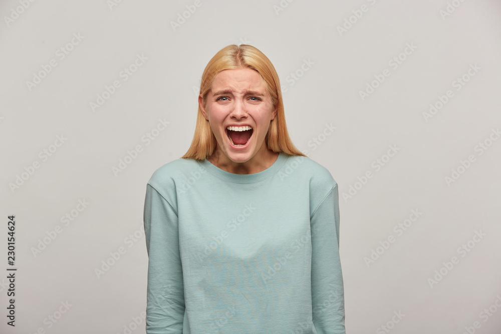 Scared blonde girl looks frightened afraid imitate scream shout, utter ...