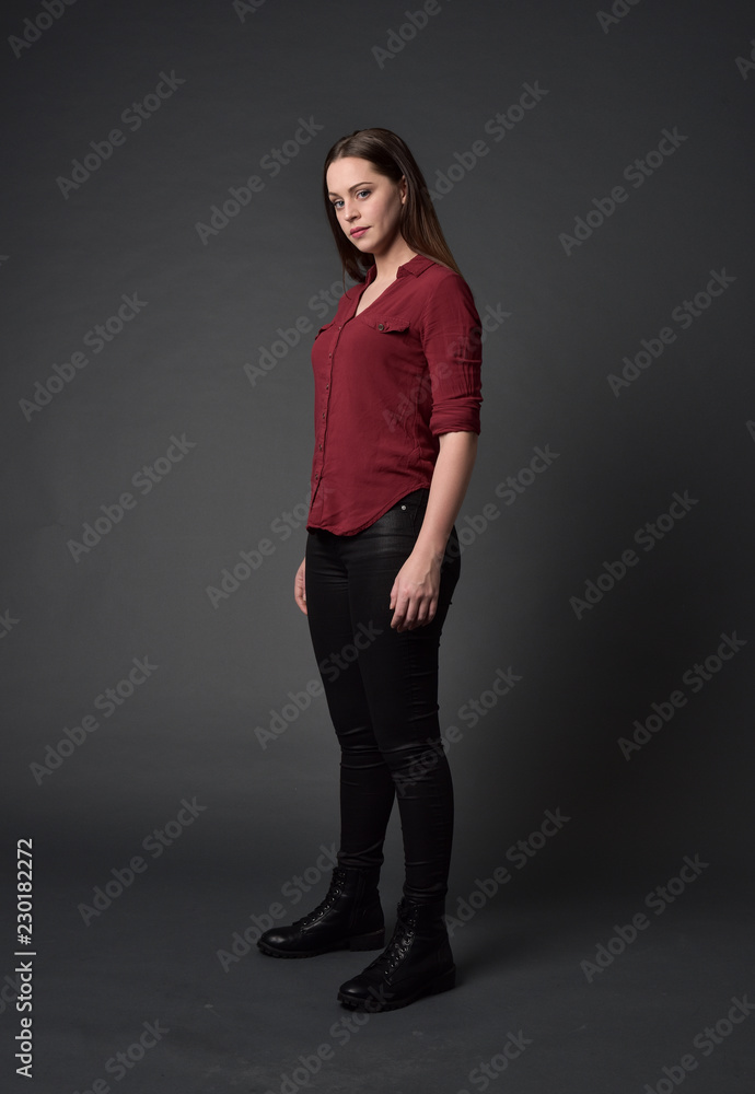 Full Length Portrait Of Brunette Girl Wearing Red Shirt And Leather