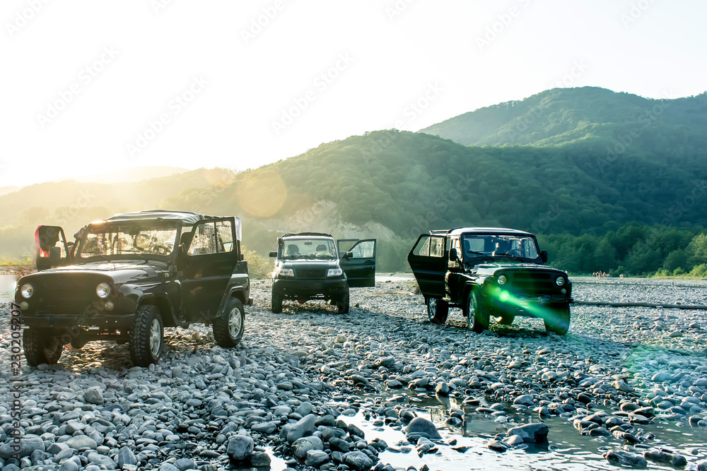 Travel concept with big 4x4 car against sunset and mountains. Closeup ...