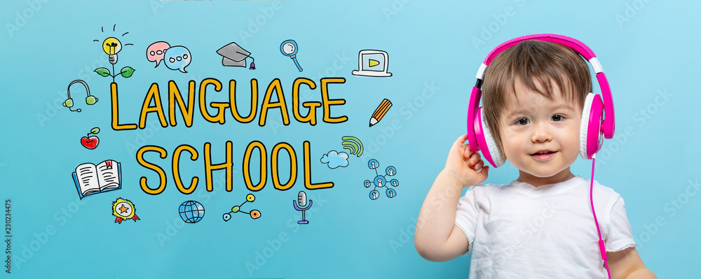 Language school with toddler boy with headphones on a blue background ...