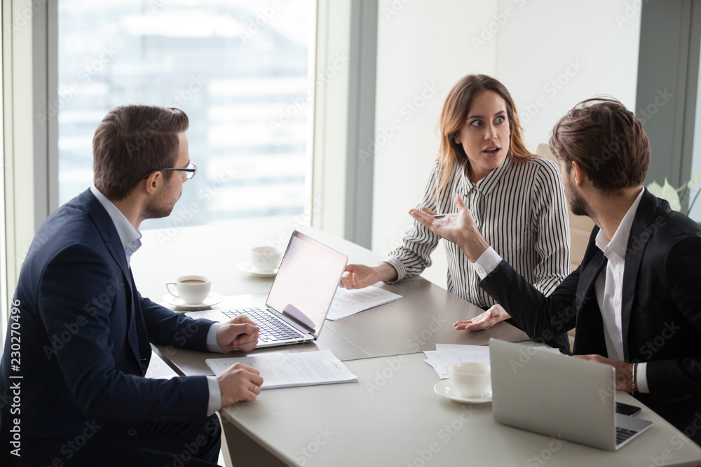 Angry man accusing shocked female colleague, intern, blaming for ...