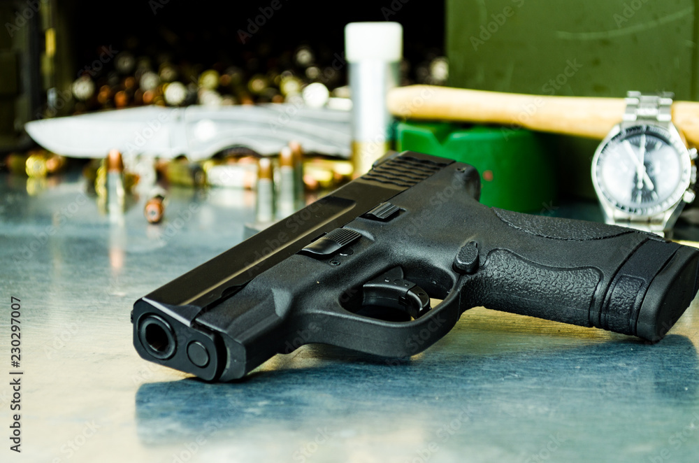 Compact 9mm pistol laying on table with ammunition and gunsmith tools ...