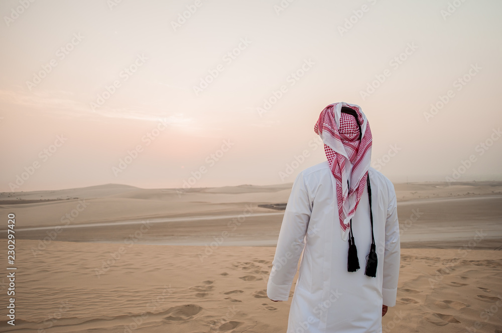 Arab man in the desert is meeting sunrise Stock Photo | Adobe Stock