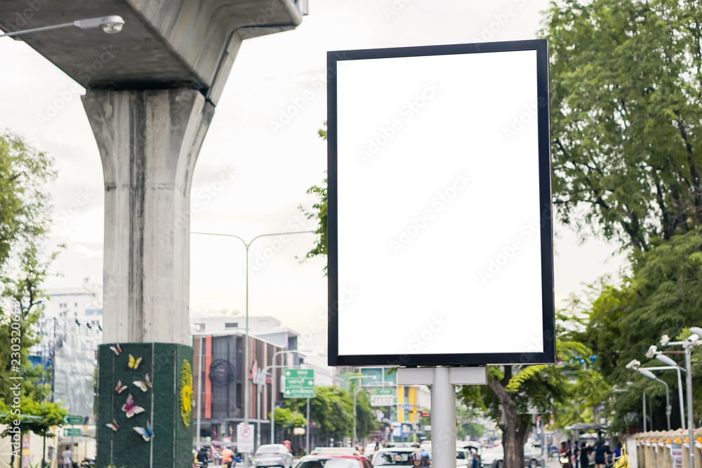 blank street billboard in urban road city area with skytrain rail line ...