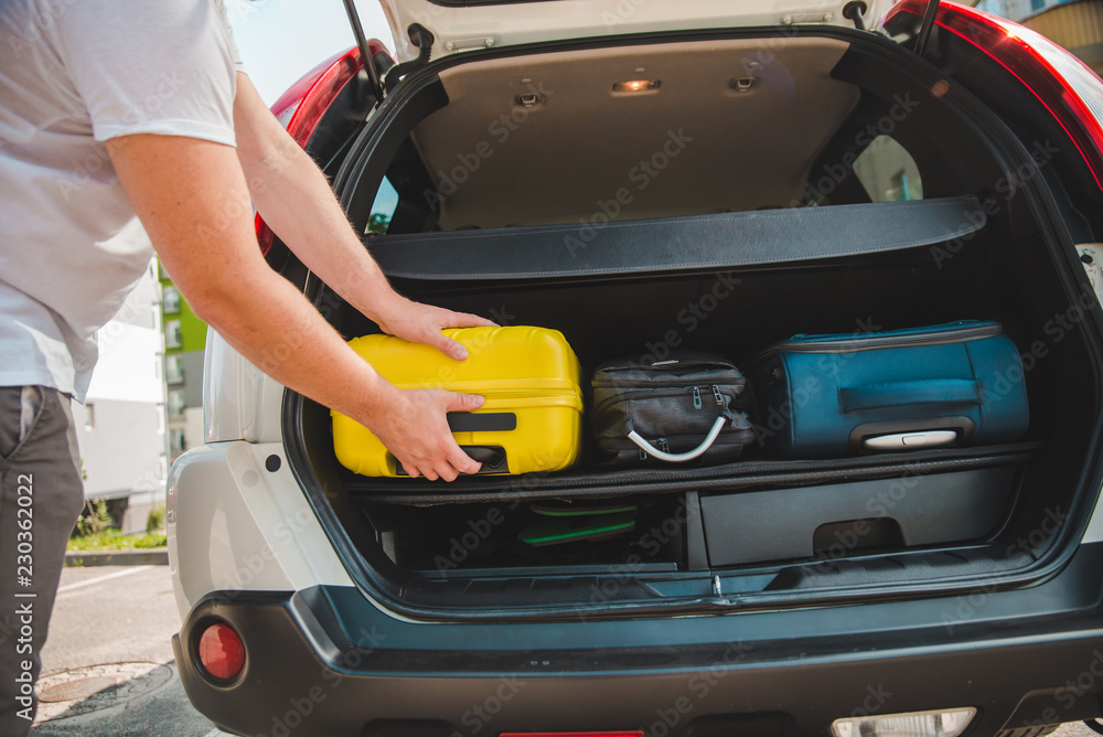 hands load bags in car trunk Stock Photo | Adobe Stock