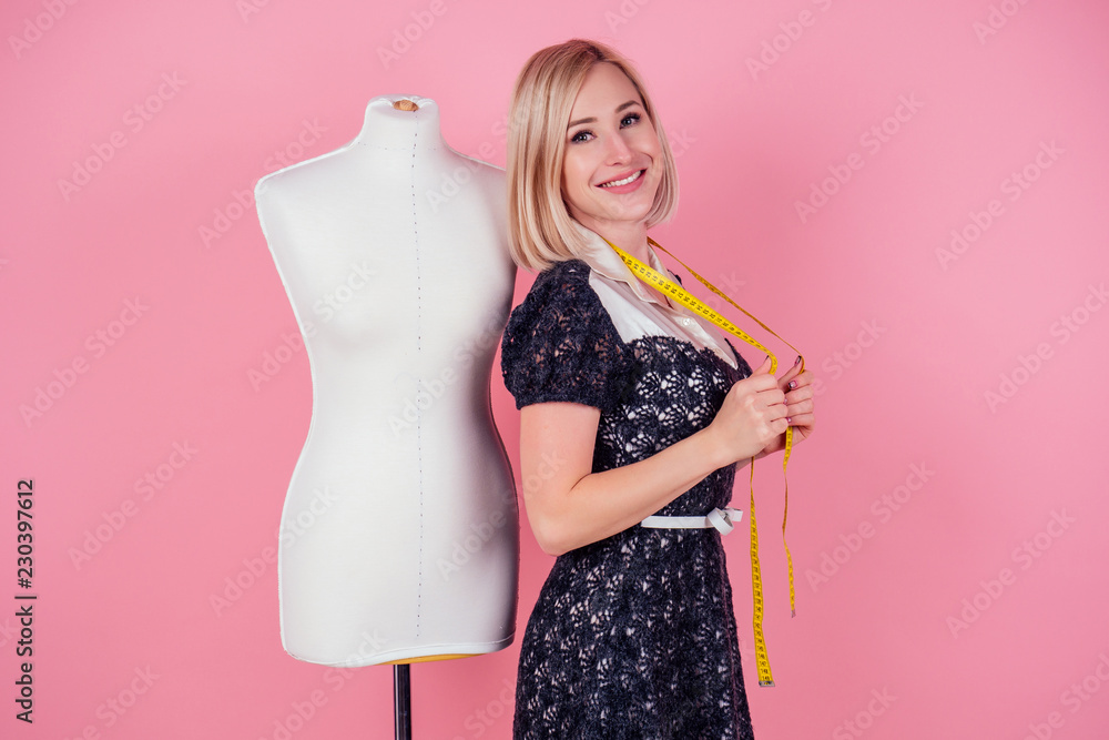 sewing pattern,sewing machine and maniken in studio pink background ...