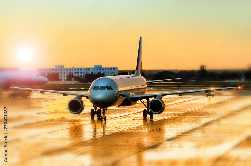 Modern passenger airplane taxiing to gate at airside apron of terminal ...