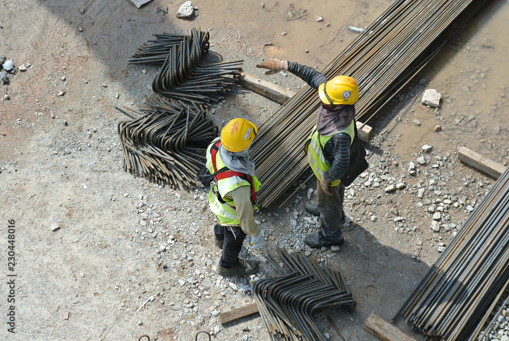 Construction workers working at the steel reinforcement bar bending ...
