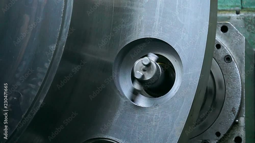 huge lathe closeup, large spindle lathe is rotating at an industrial ...