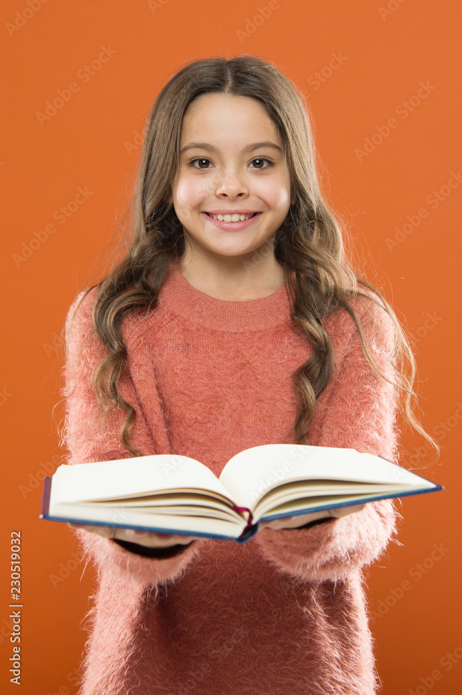 Girl hold book read story over orange background. Child enjoy reading ...