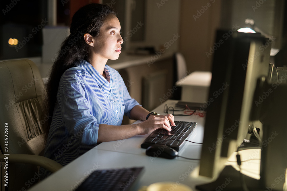 Side view portrait of Mixed-race young woman typing while using ...