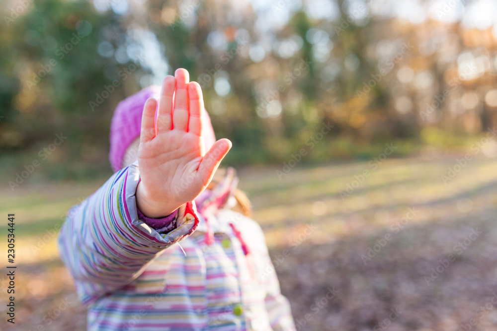 Little girl showing hand in stop gesture Stock Photo | Adobe Stock