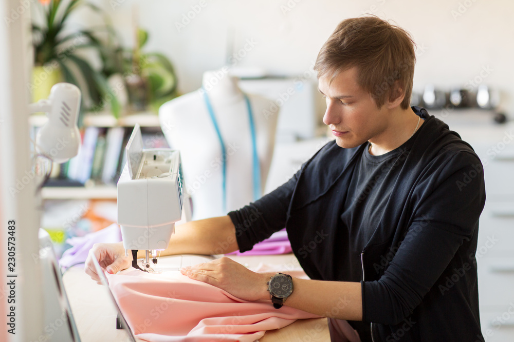people, clothing and tailoring concept - fashion designer with sewing ...