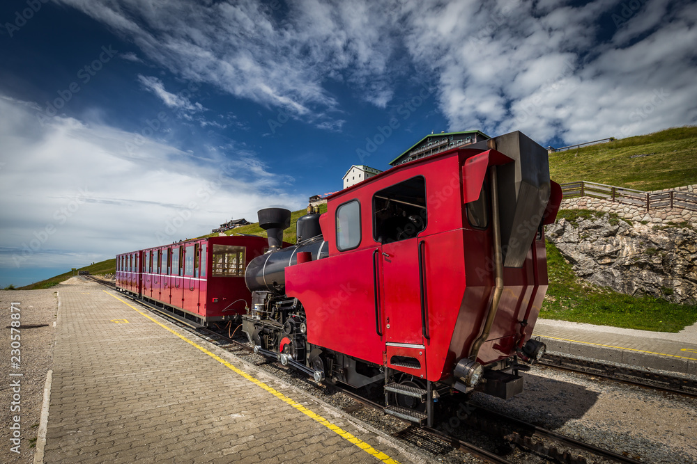 Red steam historic locomotive waiting in Schafbergspitze station near ...