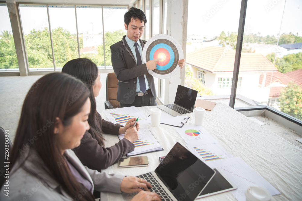 businessman pointing to company goal and yearly target in meeting using ...