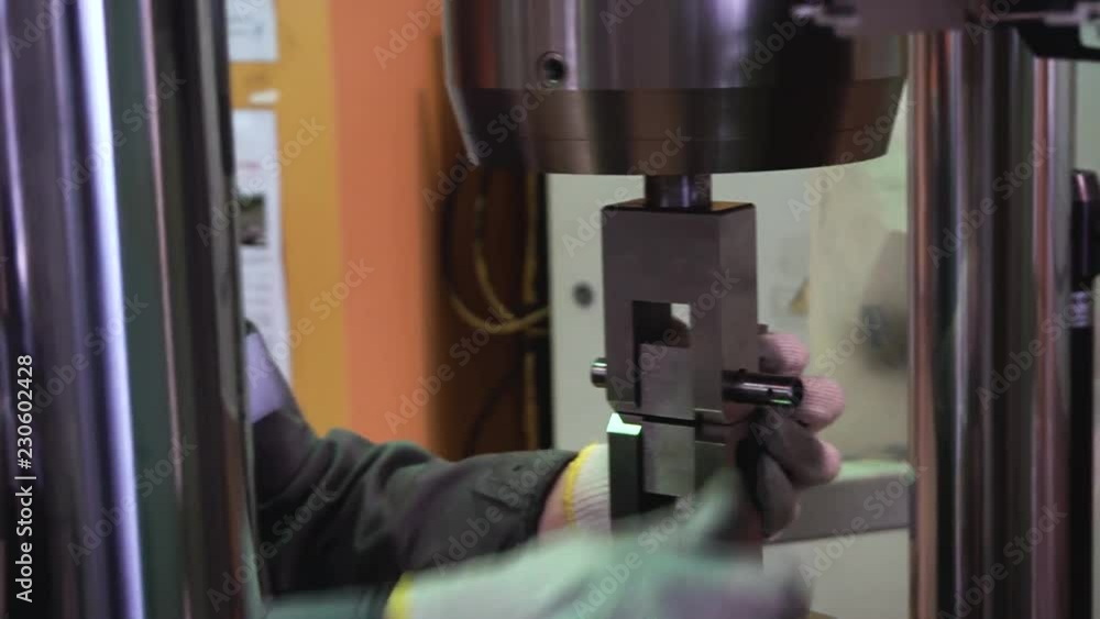 Metal sample is tested for compressive strength. Footage. Close-up of ...