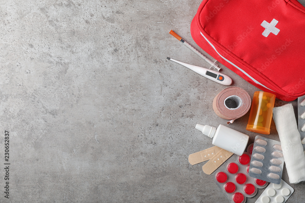 Flat lay composition with first aid kit and space for text on gray ...