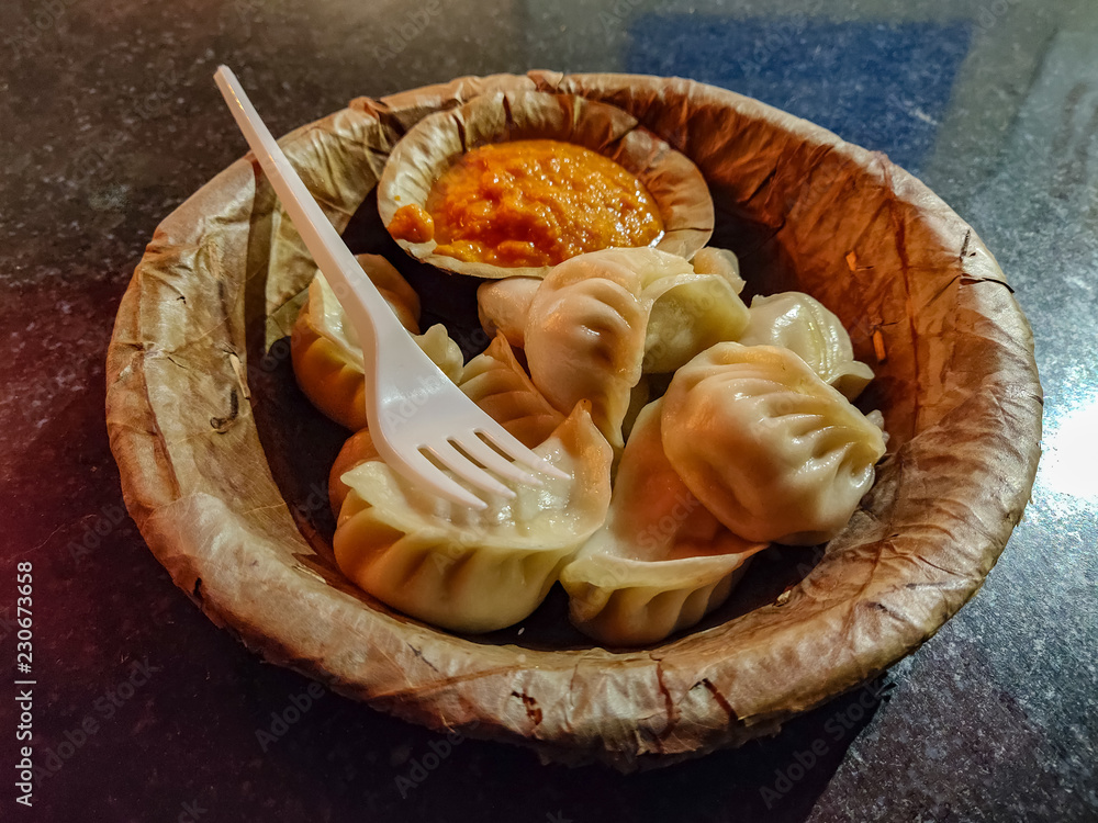 Steam momo served in a leaf plate with plastic fork Stock Photo | Adobe ...