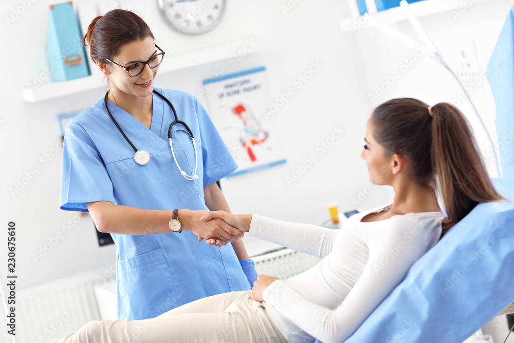 Adult woman having a visit at female doctor's office Stock Photo ...