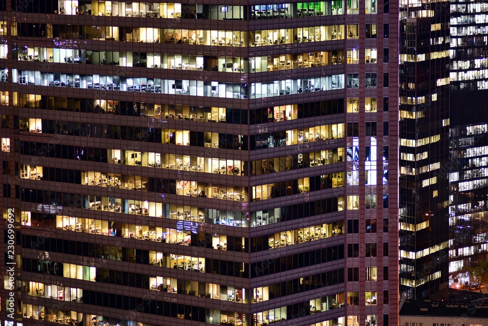 Office building at night. Late night at work. Glass curtain wall office ...