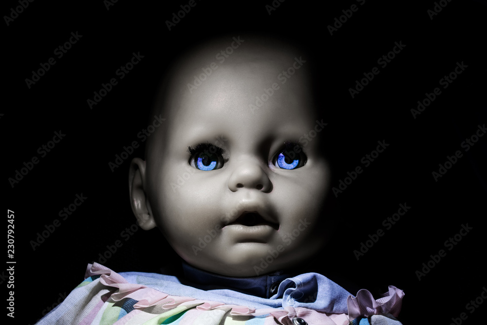 The face of a terrible demonic doll with bright blue eyes Stock Photo ...