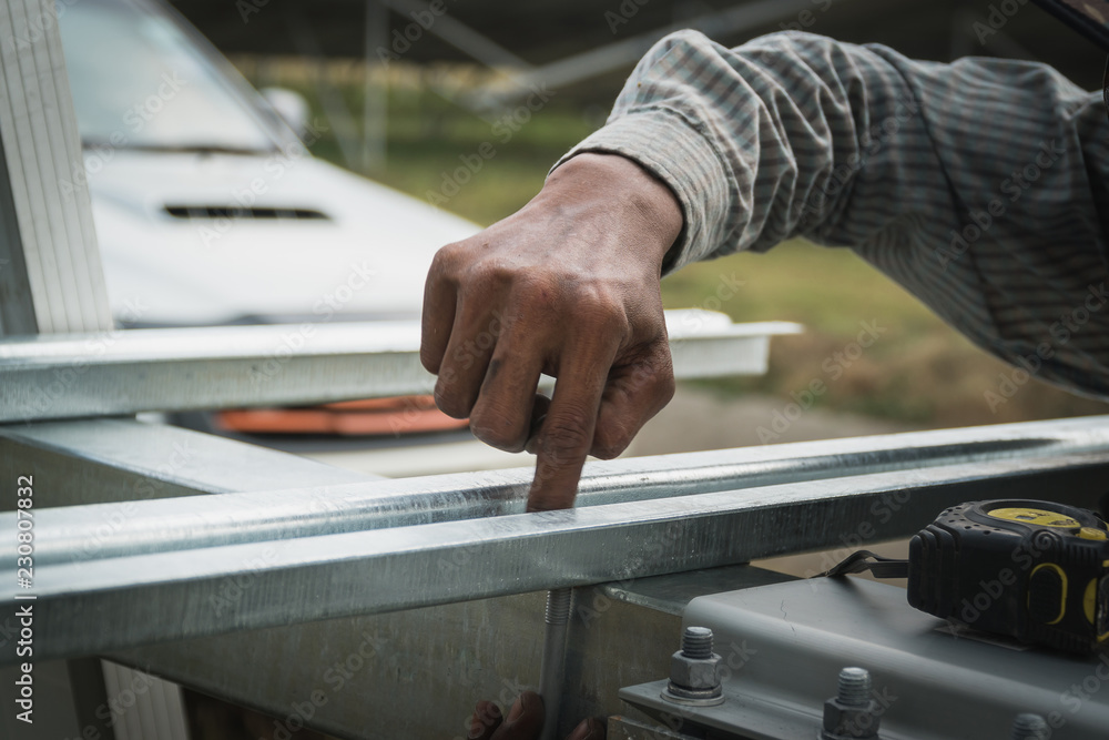 engineer and electrician installing solar power plant; scope of work at ...