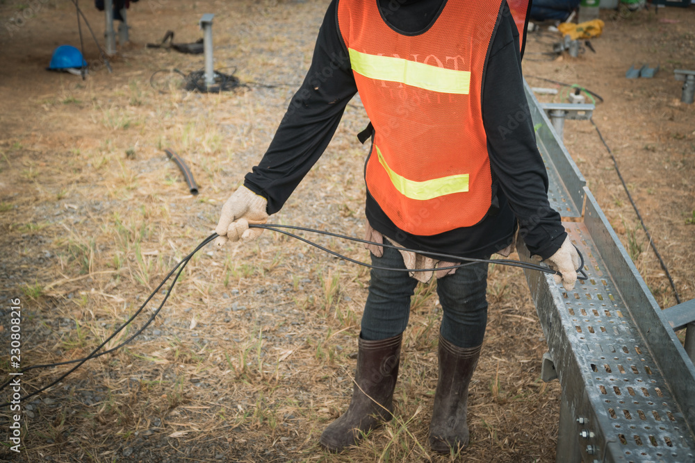 engineer and electrician installing solar power plant; scope of work at ...