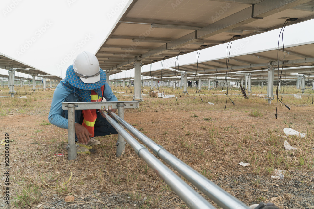 engineer and electrician installing solar power plant; scope of work at ...
