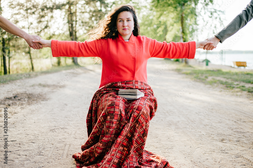 Assistance for young woman sitting in disabled chair outdoor. Help and ...