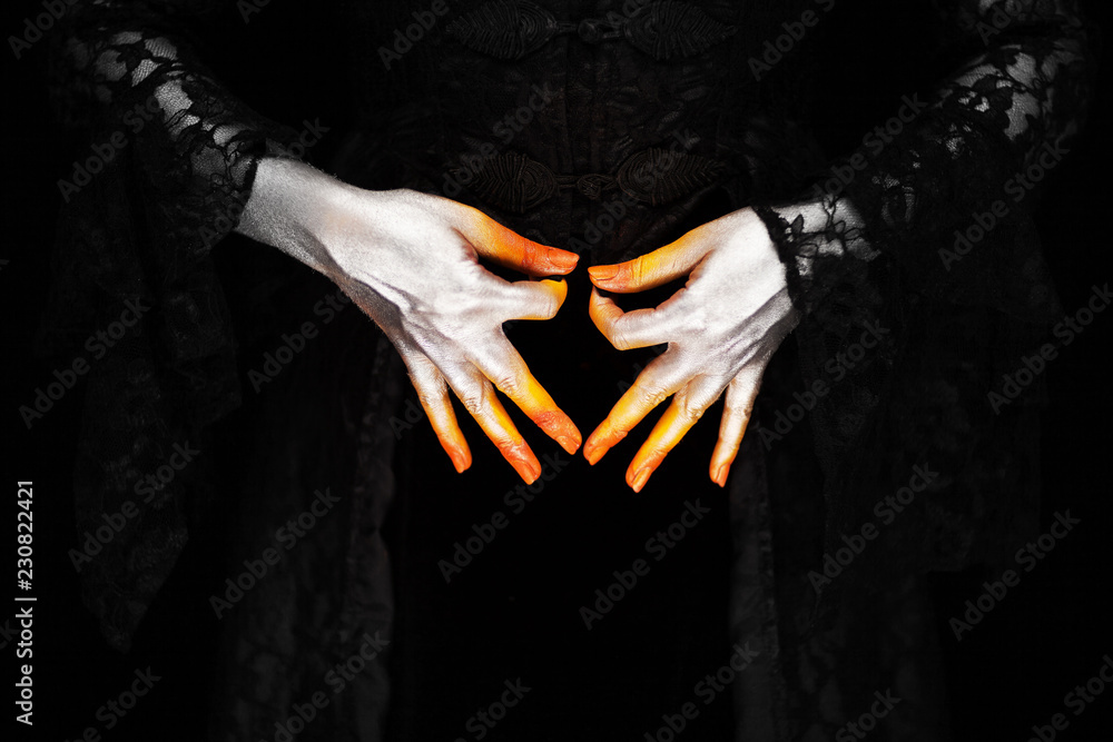 Creepy halloween vampire hands close up in red orange and silver on ...